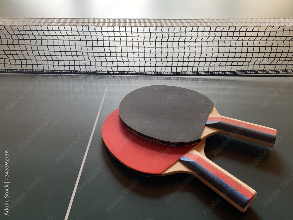 Ping-pong rackets on the tennis table. Racket for table tennis on a ...