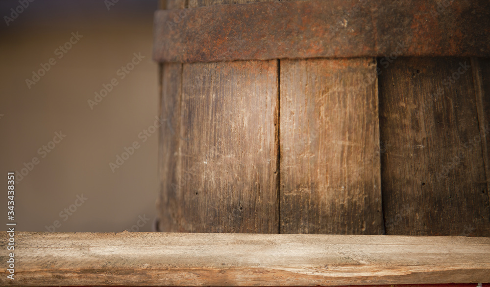 Old wood table top with stained wood backdrop in dark room background ...