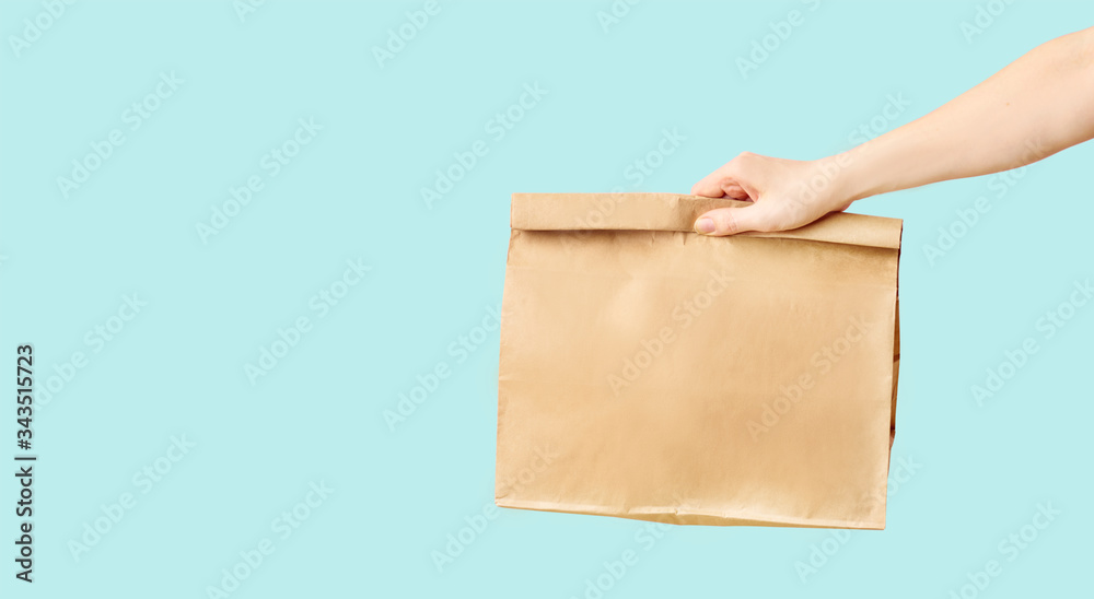 Female hand receiving brown clear empty blank paper bag for food ...