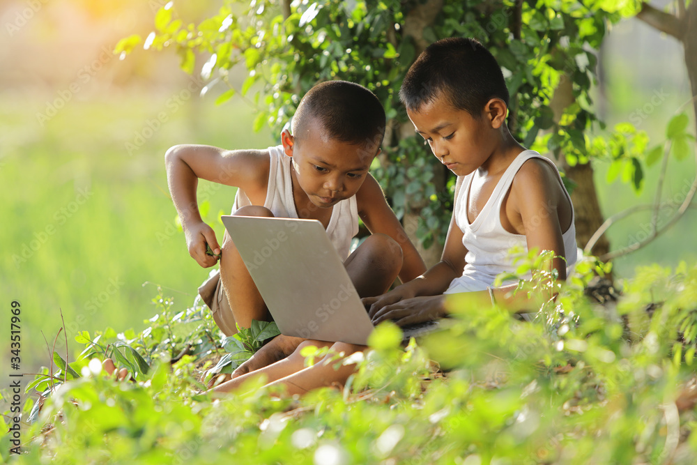 Two boy in the countryside is studying via wireless internet. Stock ...