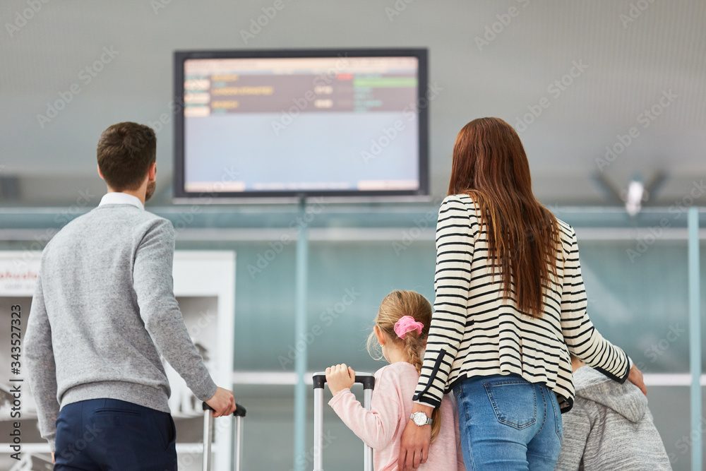 Family looks on the scoreboard after their flight Stock Photo | Adobe Stock