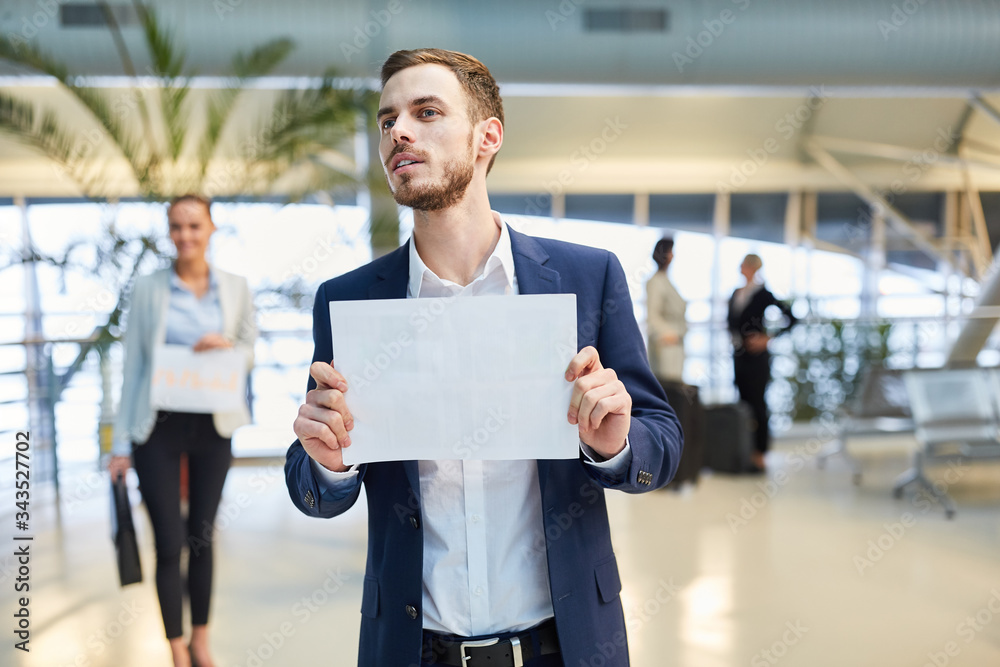 Business man at the airport holding a welcome sign Stock Photo | Adobe ...