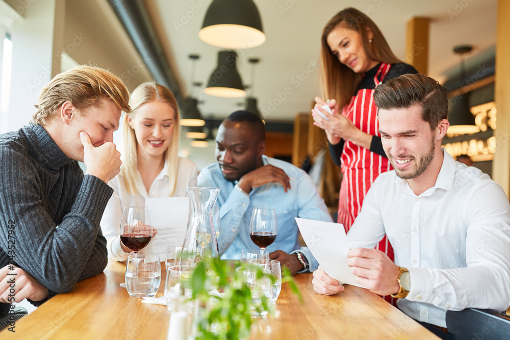 Group of young people when ordering in the restaurant Stock Photo ...