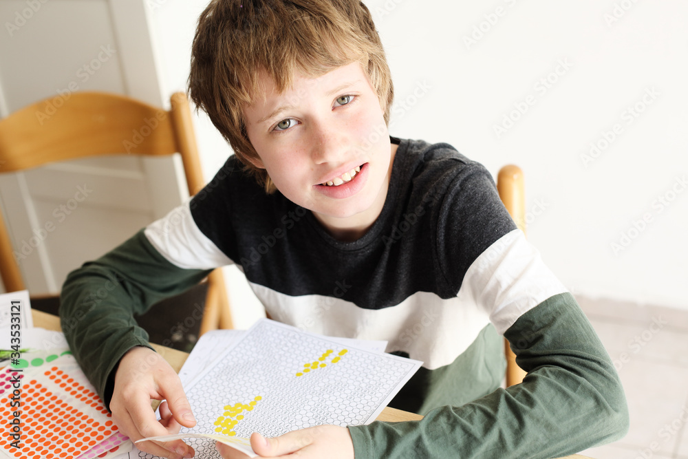 Cute 12 years old autistic boy drawing Stock Photo | Adobe Stock