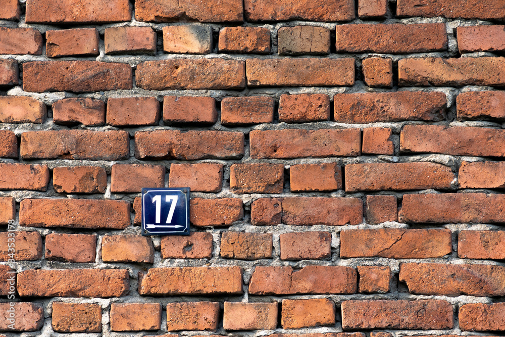 Number seventeen, a metal sign on a red brick wall Stock Photo | Adobe ...