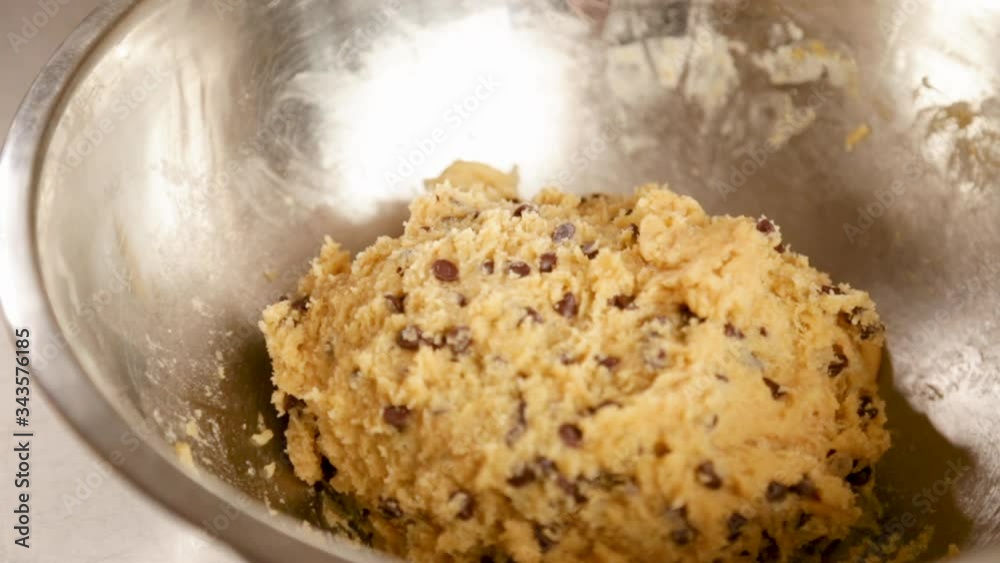 Mixing ingredients to make chocolate chip cookies - mixing cookies in a ...