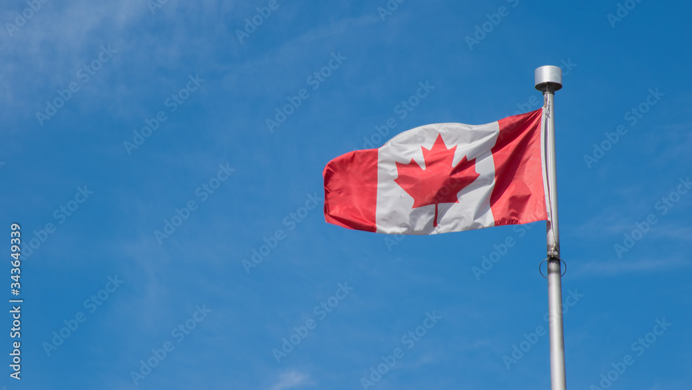 Canadian flag pole on blue sky with copy space background. Canada flag ...