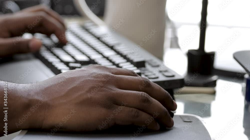 close up shot of an African American male hand using a computer mouse ...