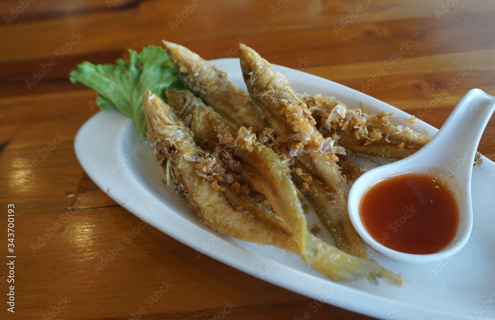 Deep fried small fish with garlic serving with chli sauce Stock Photo ...