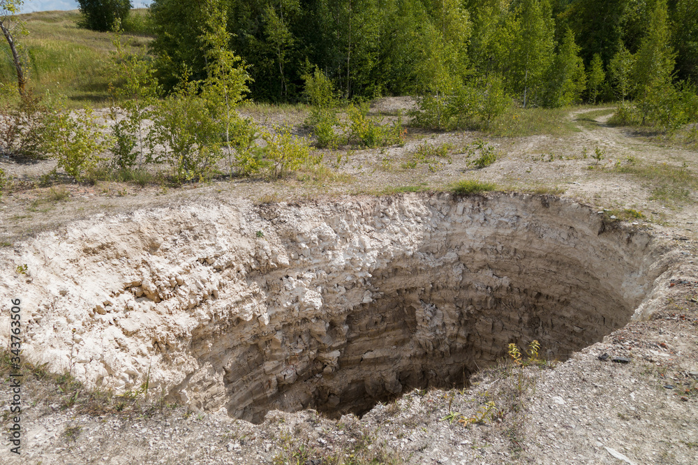 Side view onto karst sinkhole. Hole formed above abandoned limestone ...