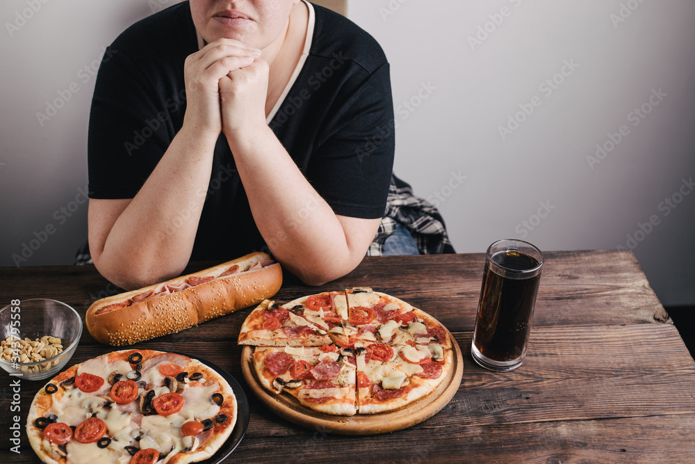 Nerve food, addiction, eating disorders, bulimia. Overweight woman sit ...