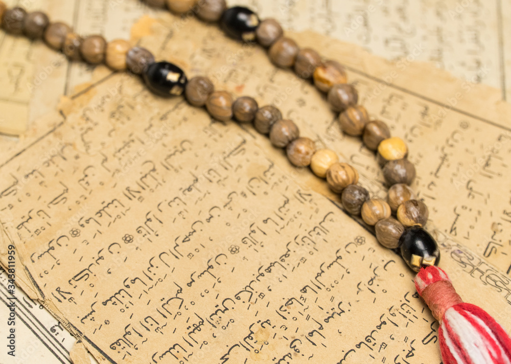 Muslim prayer beads with ancient pages from the Koran. Islamic and ...