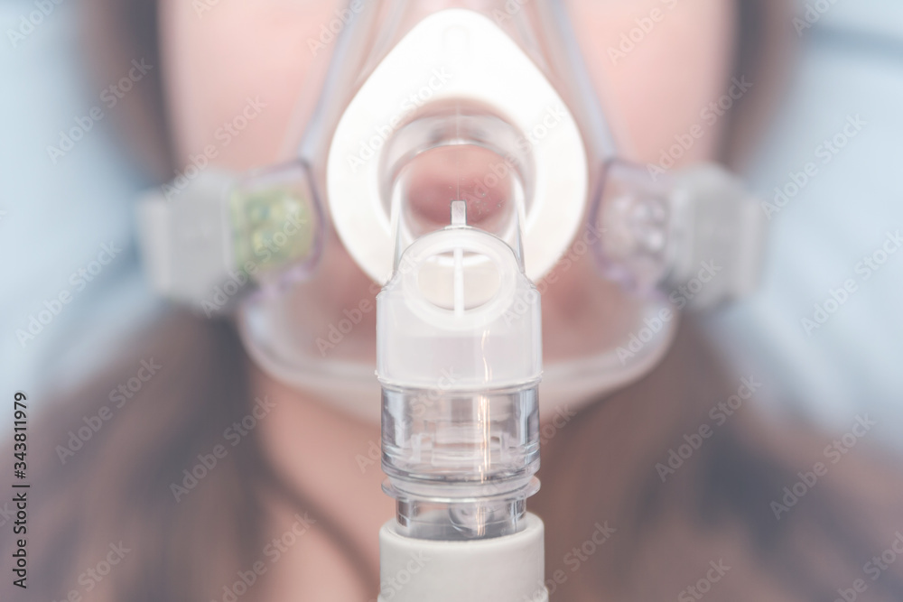 oxygen mask on the girl's face. resuscitation concept. treatment of ...