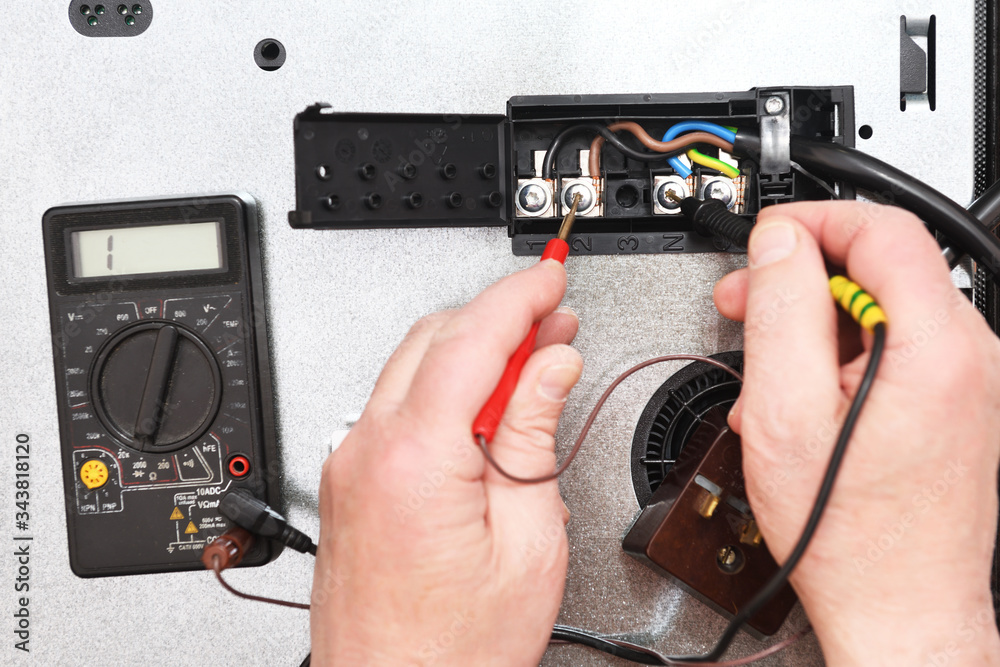 A professional electrician checks the connection quality, contact ...