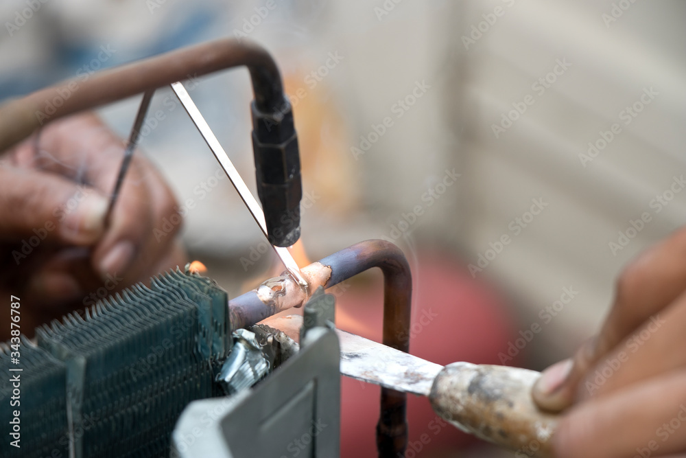 Repairing air condition compressor by welding leaked pipe with lead ...