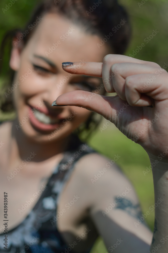 Small hand sign. Young woman doing a sign for a small thing with the ...
