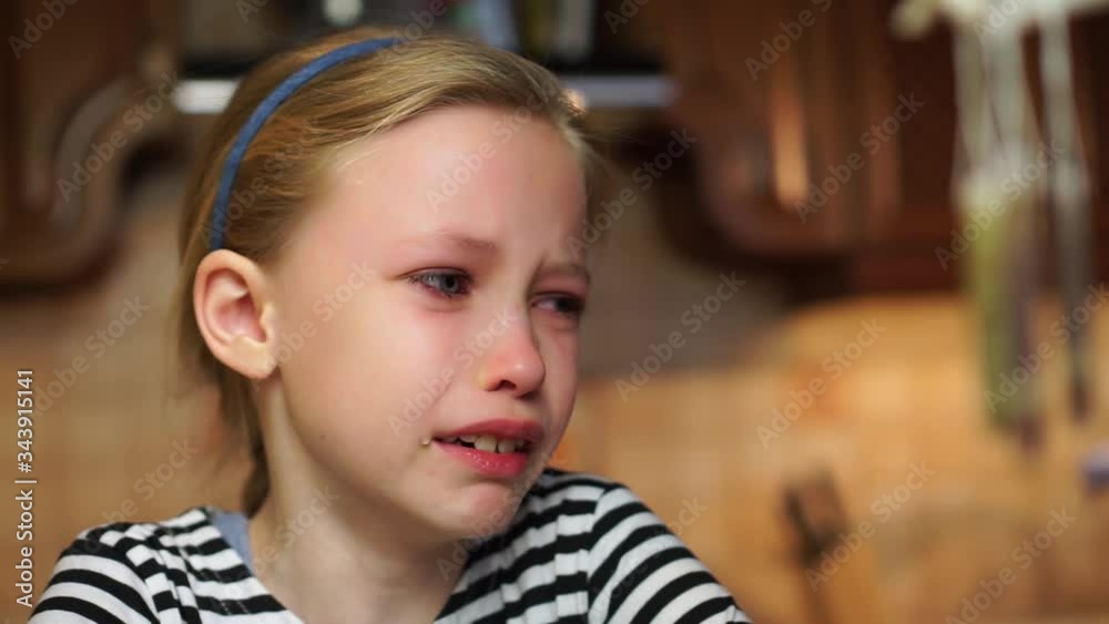 Blond beautiful child girl in striped dress crying badly tears drop ...