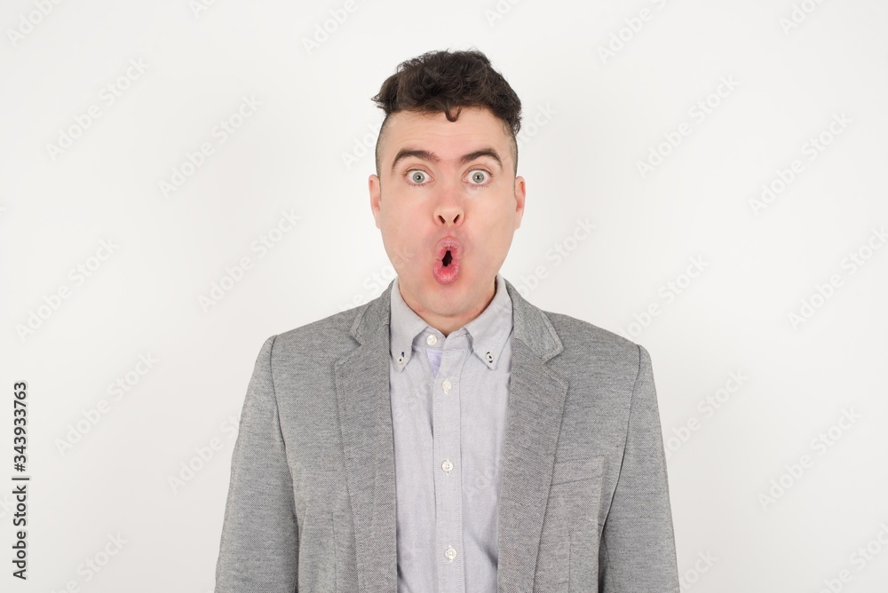 Headshot of goofy surprised bug-eyed young man student wearing casual ...