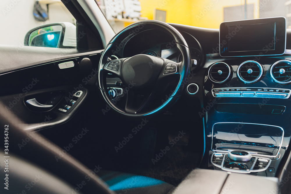 Dark luxury car Interior - steering wheel, shift lever and dashboard ...