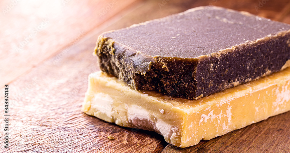 sugar cane sweets, molasses in tablets, on wooden background. consumed ...