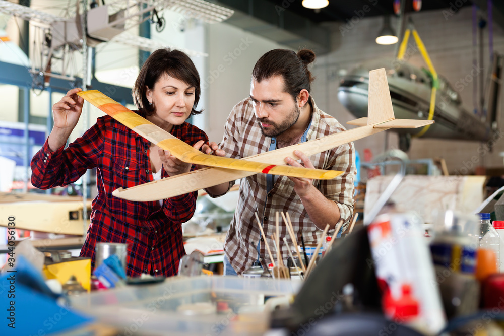 Positive couple enjoying their hobbies - modeling light airplanes in ...