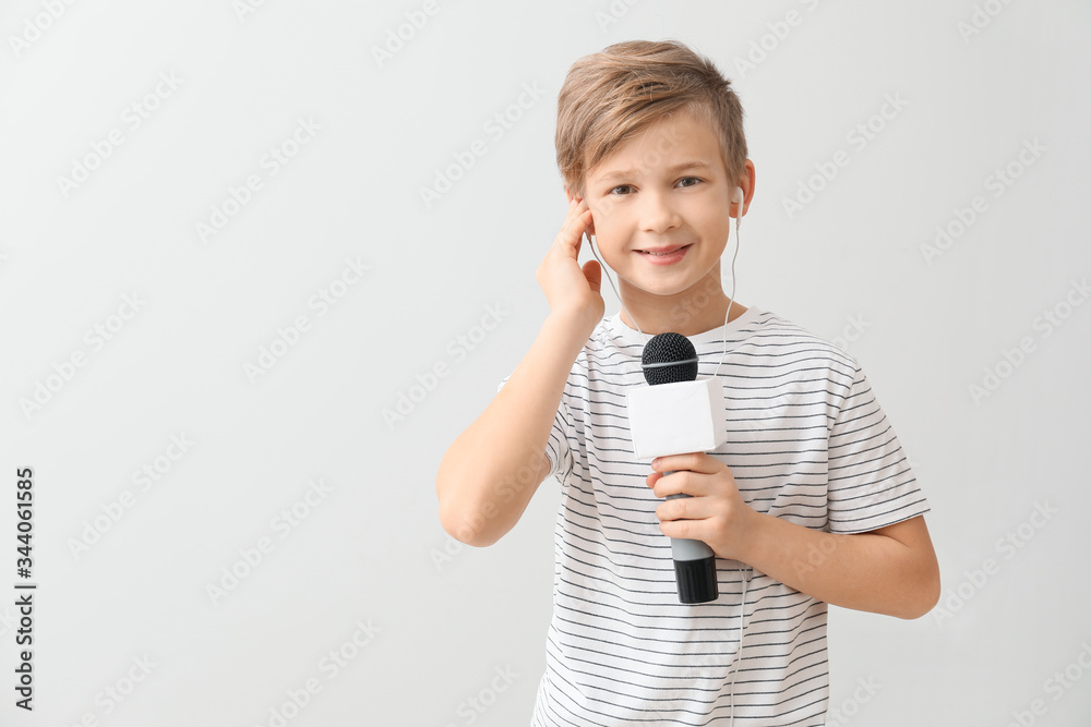 Little journalist with microphone on white background Stock Photo ...