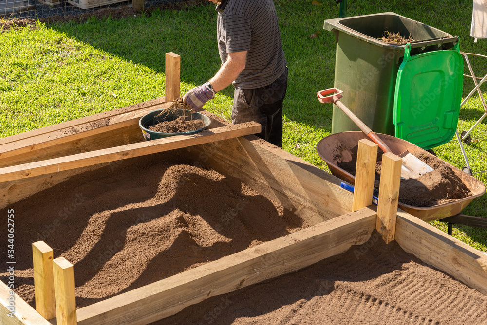 Sifting soil through a garden sieve to remove rubbish Stock Photo ...