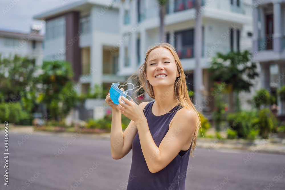 Quarantine is over concept. Woman taking off mask against the ...
