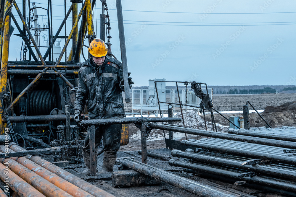 Workover rig working on a previously drilled well trying to restore ...