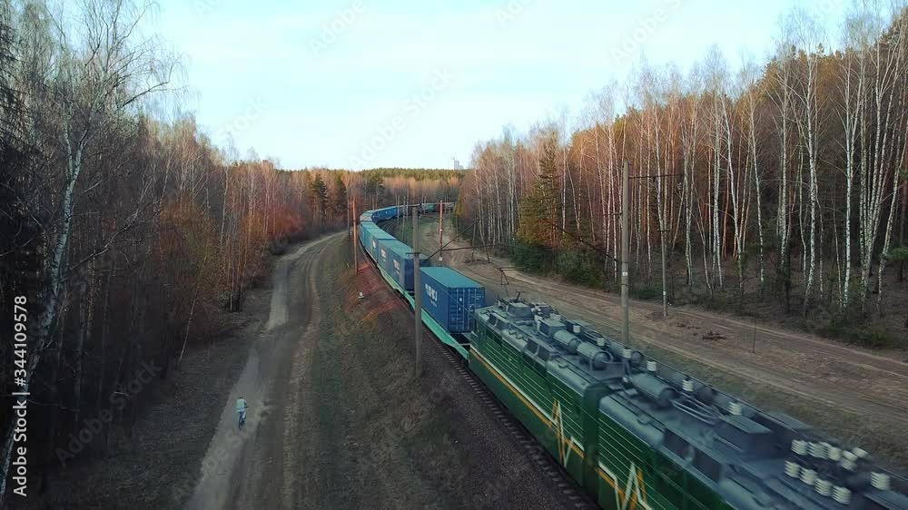 an electric locomotive Freight train carries by two-sided railroad in ...