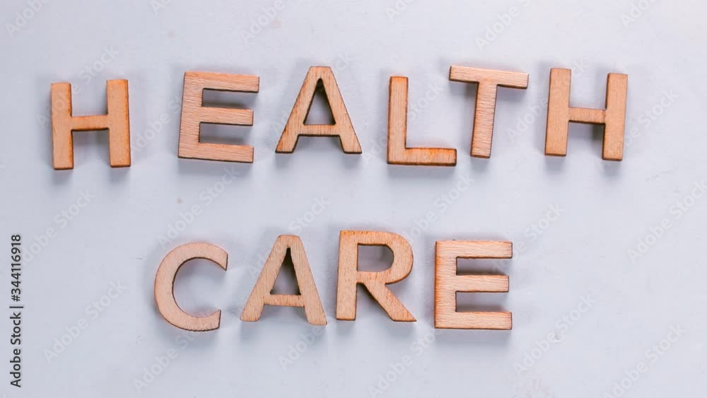 Word health care. Word made by dancing letters made of wood. Caring for ...