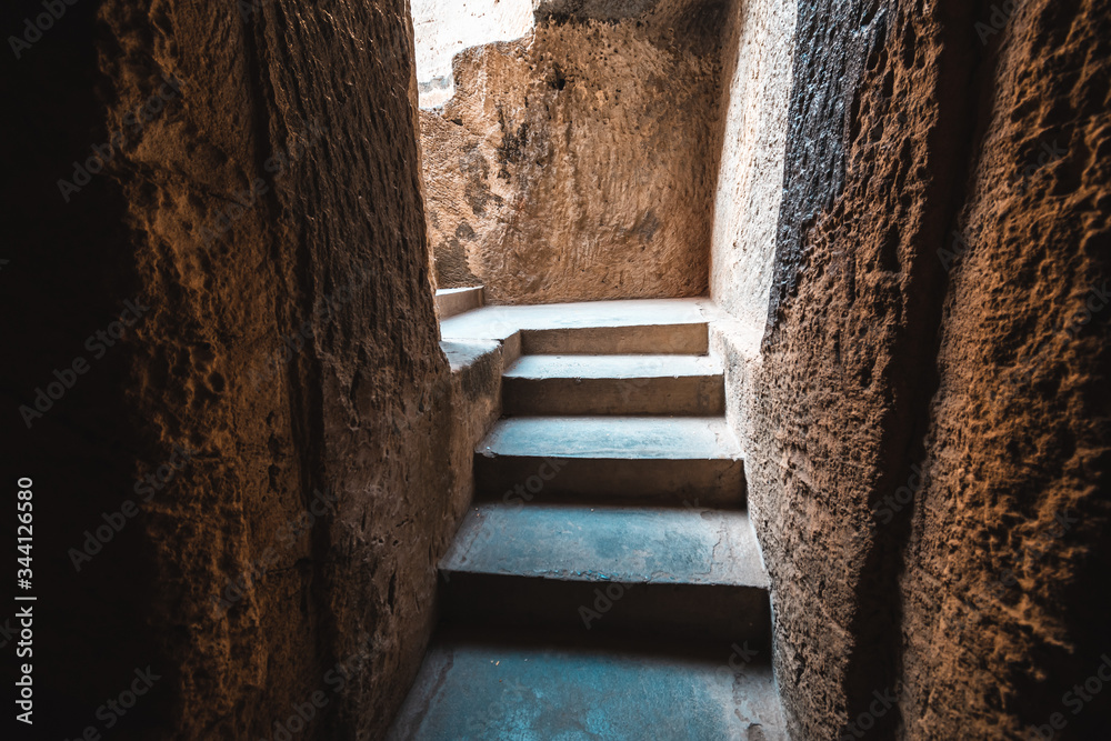 The rock cut steps leading to the ancient Buddhist caves inside the ...