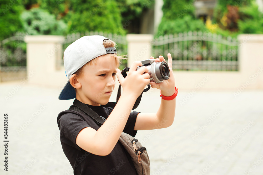 Boy with a digital camera taking pictures. School project for kids ...