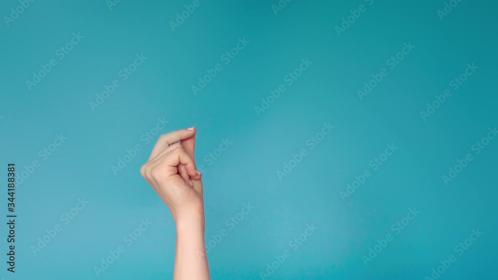 Woman hand snaps her fingers over blue background. Female hand with ...