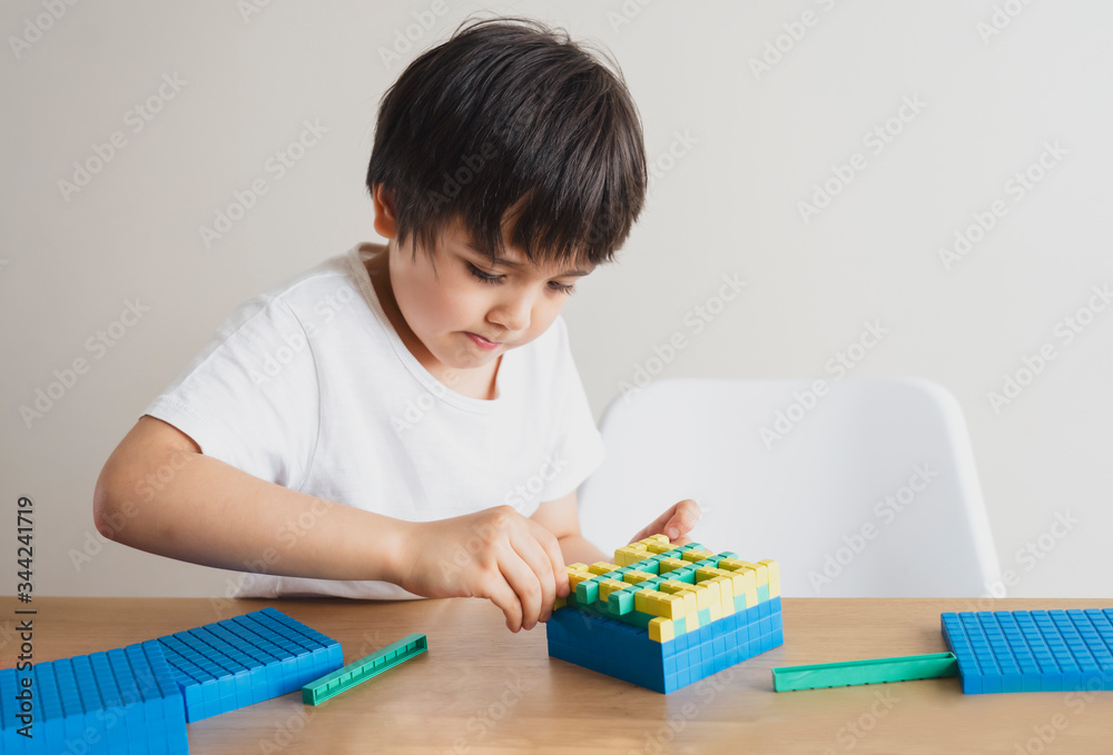 School kid using plastic block counting number, Child boy studying math ...