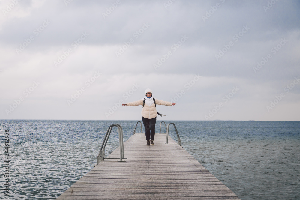 Concept of freedom relaxation. woman relaxing on pier. Woman hiker ...