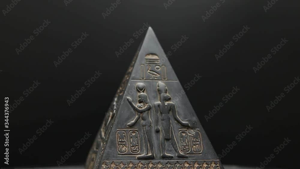 pyramid figure. pyramid figurine on a black background. the pyramid is ...