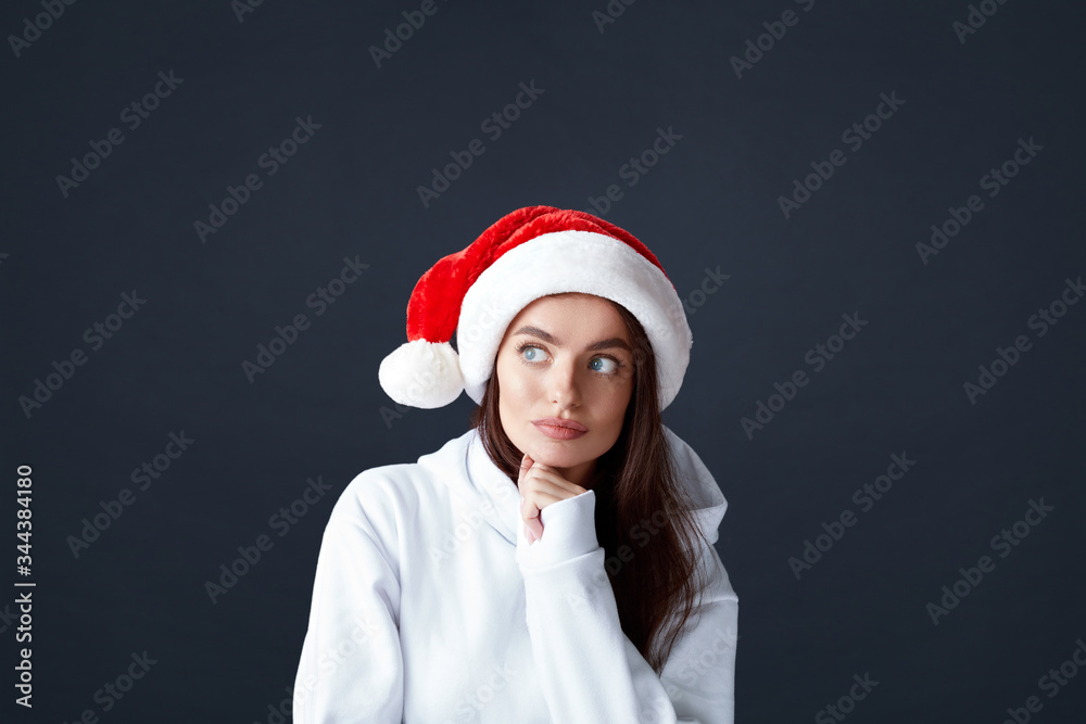 Santa Girl. Beautiful Woman In Christmas Hat Portrait. Thinking Model ...