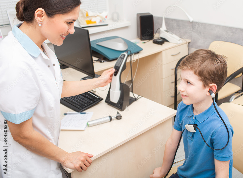 Female otolaryngologist doing a hearing test in a boy. Tympanometry ...