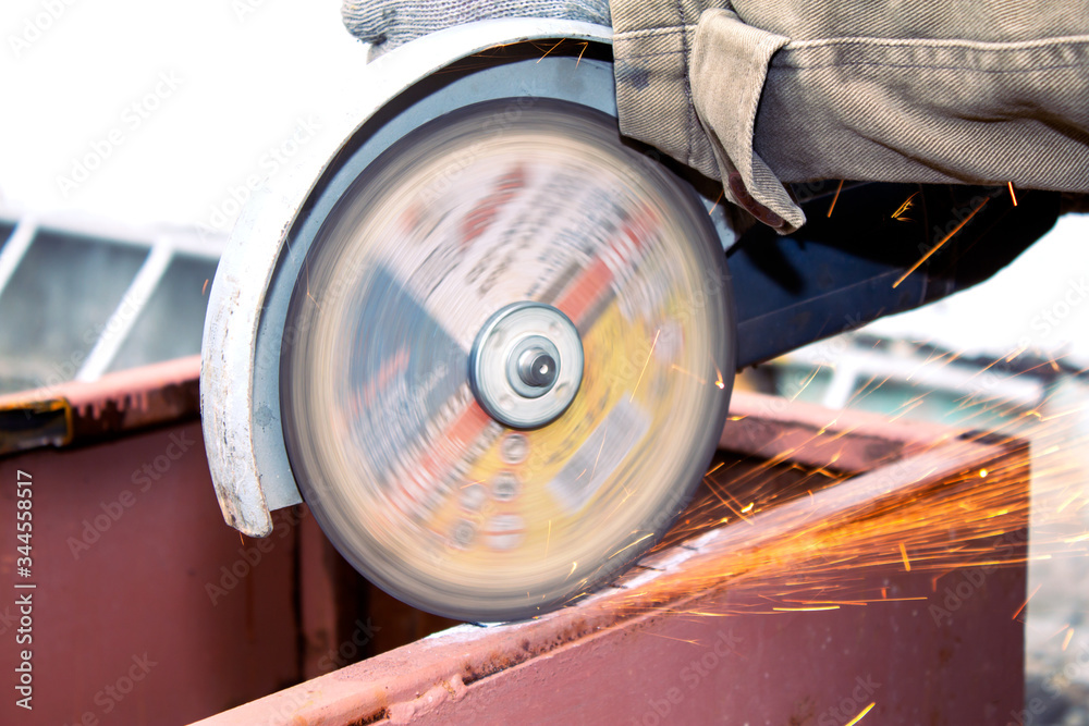 Angle grinder cutting steel with sparks. Hand work, Circular grinder ...