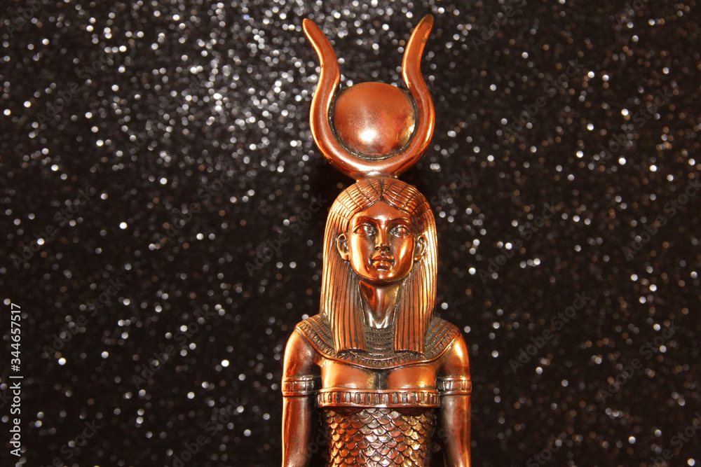 The Egyptian goddess ISIS on a black background. A bronze Egyptian ...