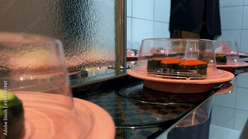 4K, Sushi on moving conveyor belt in a Japan restaurant. Traditional ...