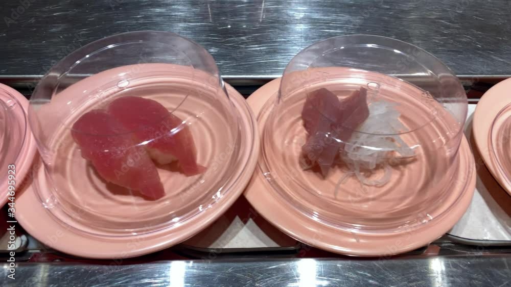 4K, Sushi on moving conveyor belt in a Japan restaurant. Traditional ...