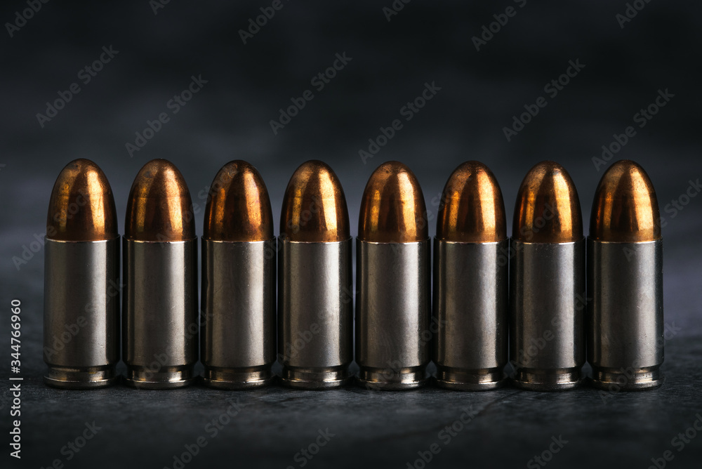 Bullet 9mm. On the dark stone table.rounds and military technology ...