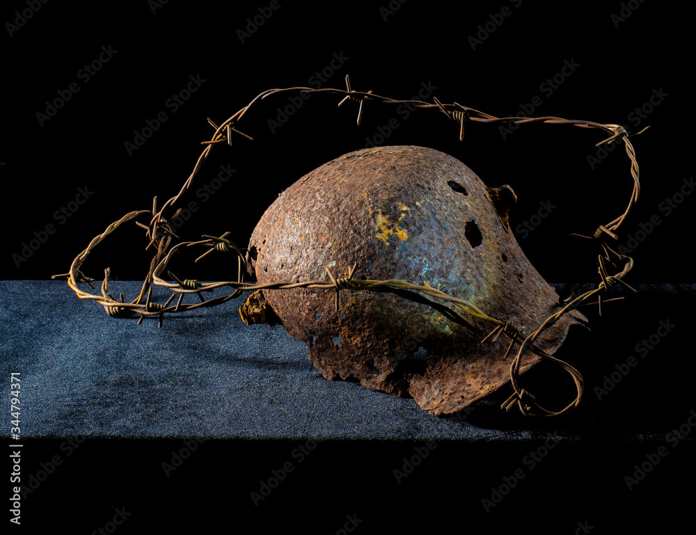 Rusty Wehrmacht helmet with barbed wire World War II on black ...