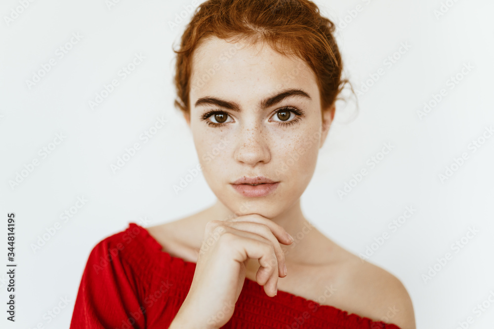 the beautiful face of a young girl with a raised, surprised eyebrow ...