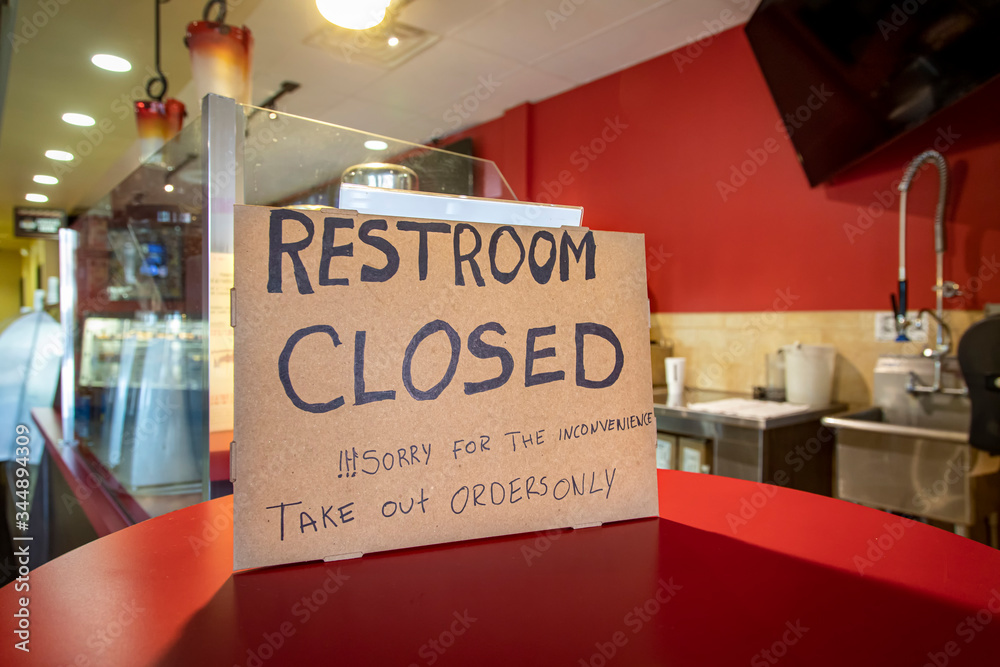 Handwritten sign at restaurant stating Restroom Closed and Take-Out ...