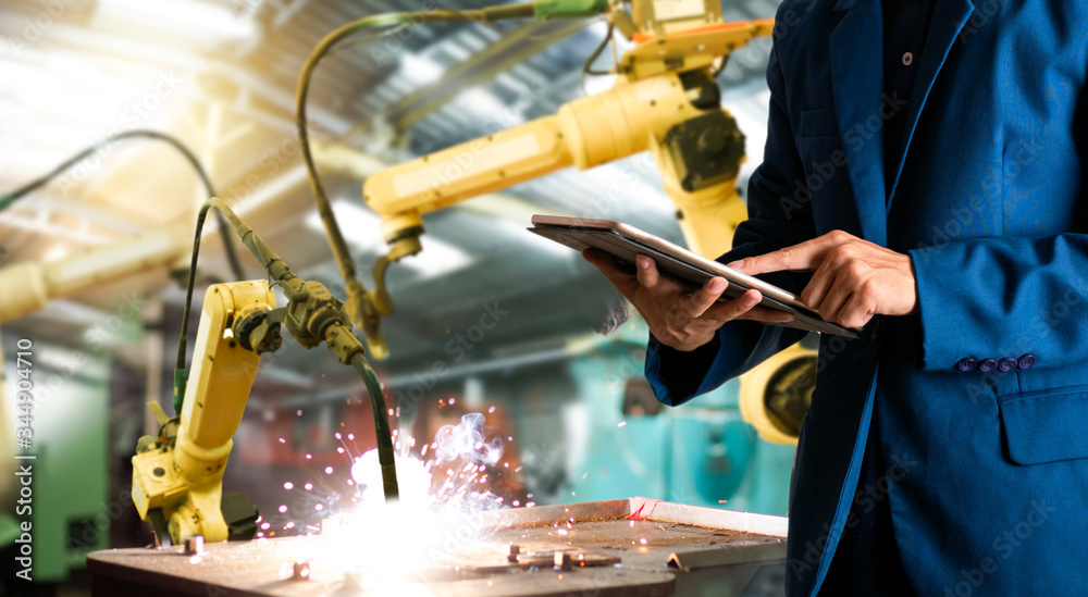 Manager or Industrial engineer working and control robotic with ...