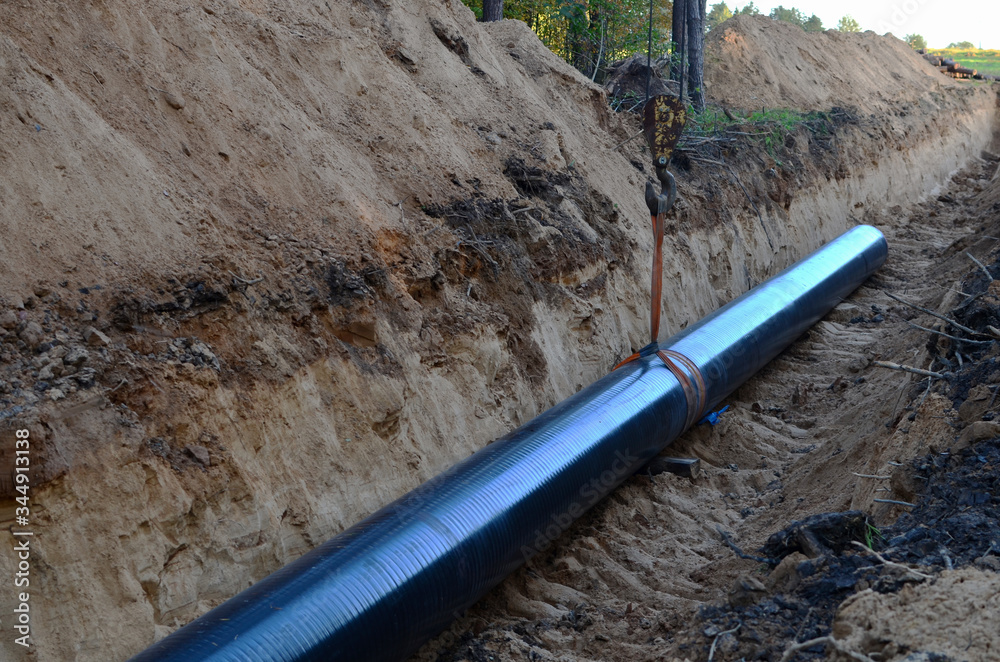 Natural gas pipeline construction work. A dug trench in the ground for ...