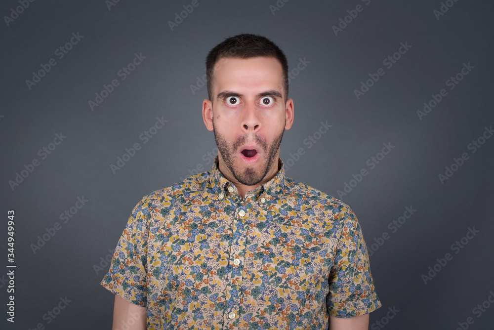 Headshot of goofy surprised bug-eyed young man student wearing casual ...